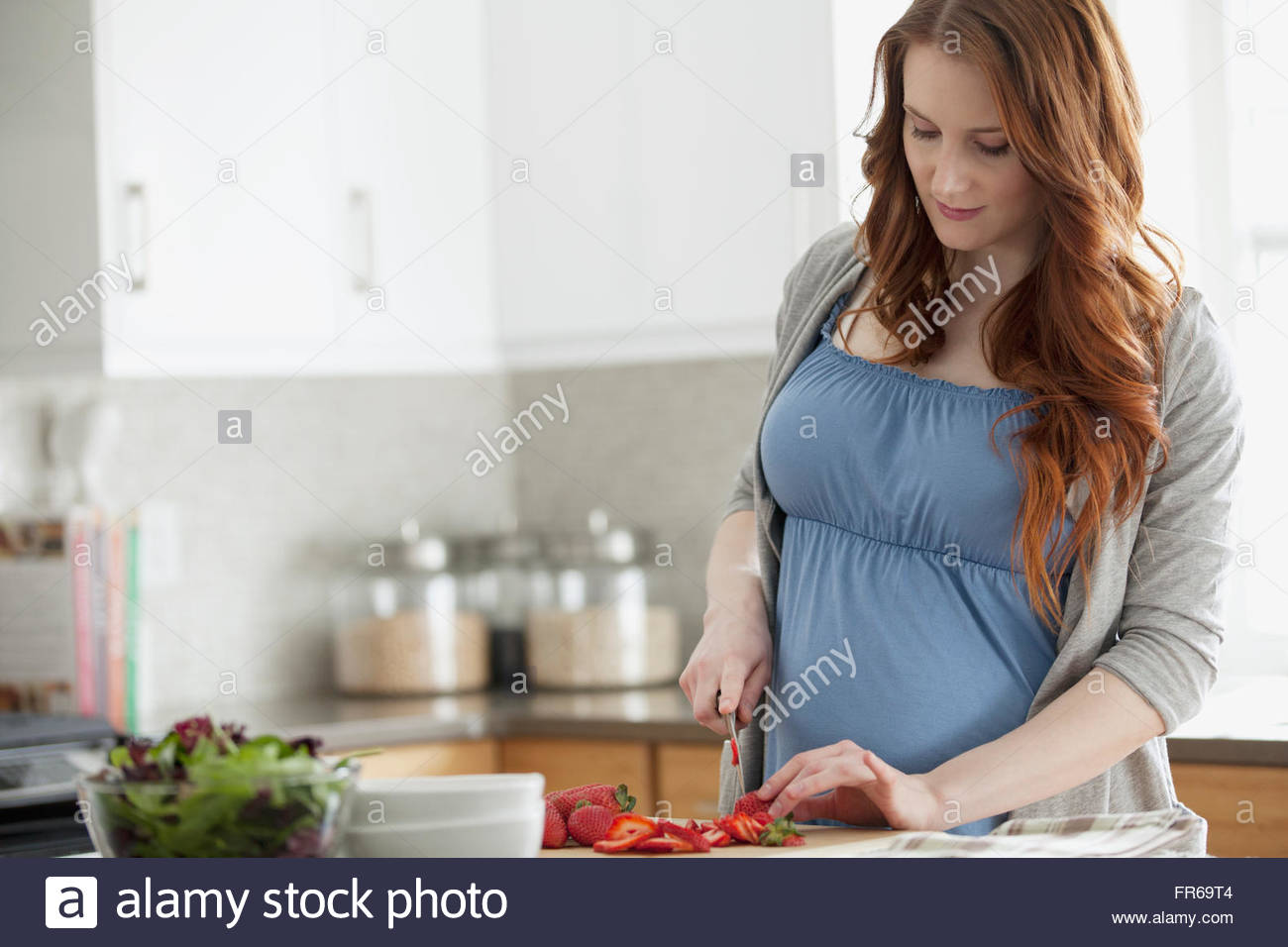 pregnant woman working in kitchen Stock Photo - Alamy