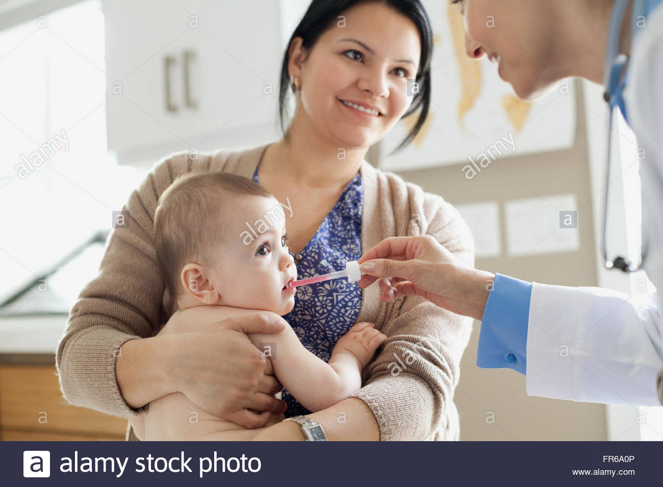 doctor examining baby Stock Photo - Alamy