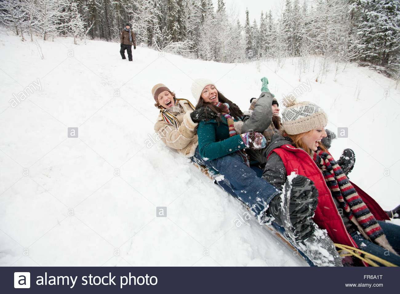 Adults friends enjoying toboggan hi-res stock photography and images ...