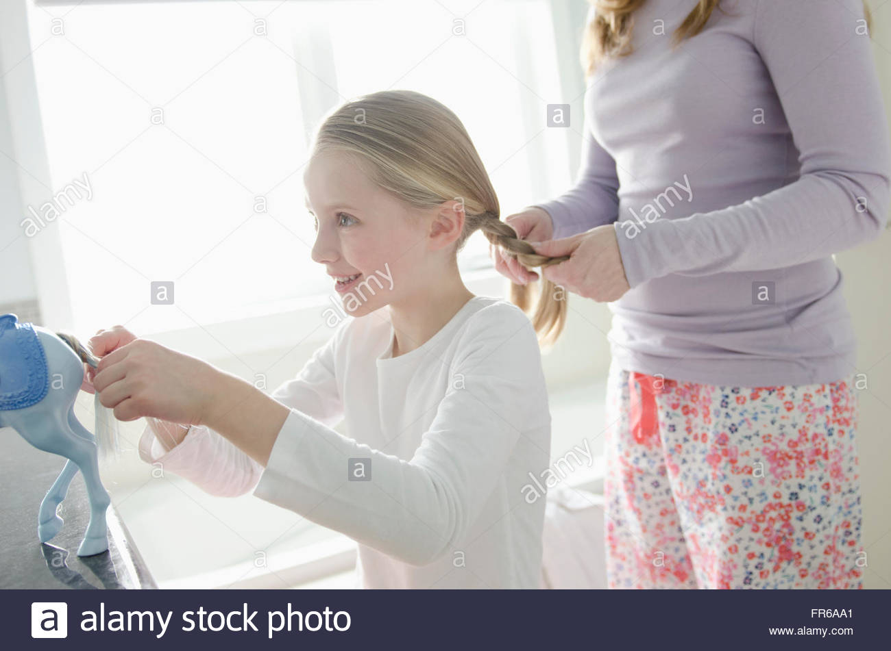 Mother braiding daughters hair hi-res stock photography and images - Alamy