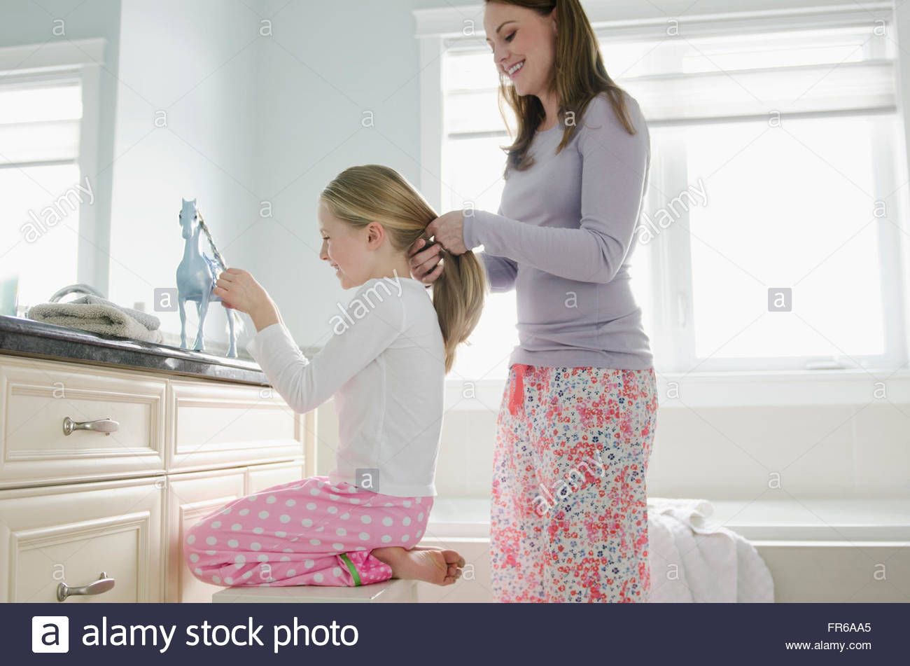 Mother braiding daughters hair hi-res stock photography and images - Alamy