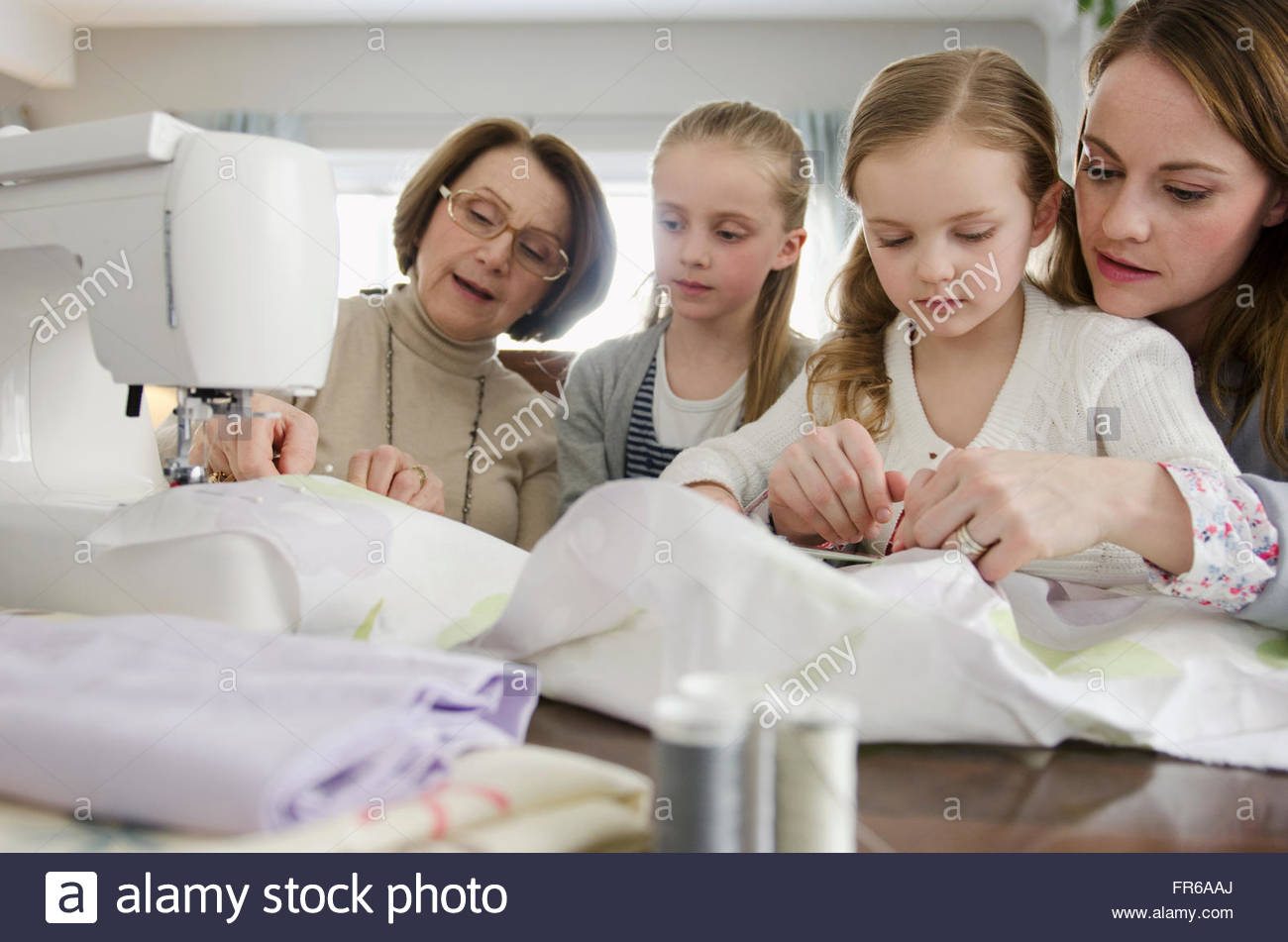 Girls together sewing hi-res stock photography and images - Alamy