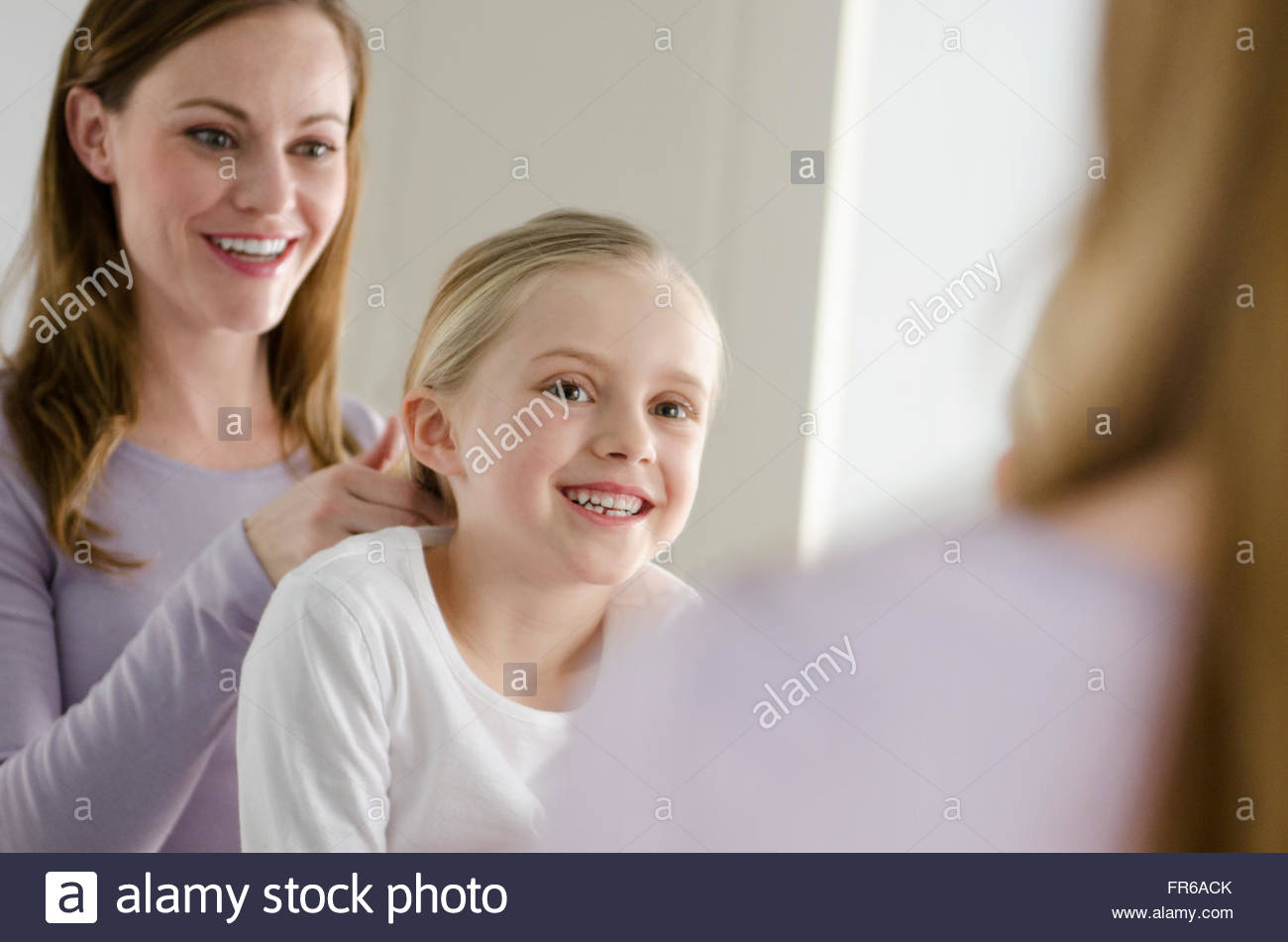 mother braiding daughters hair Stock Photo - Alamy