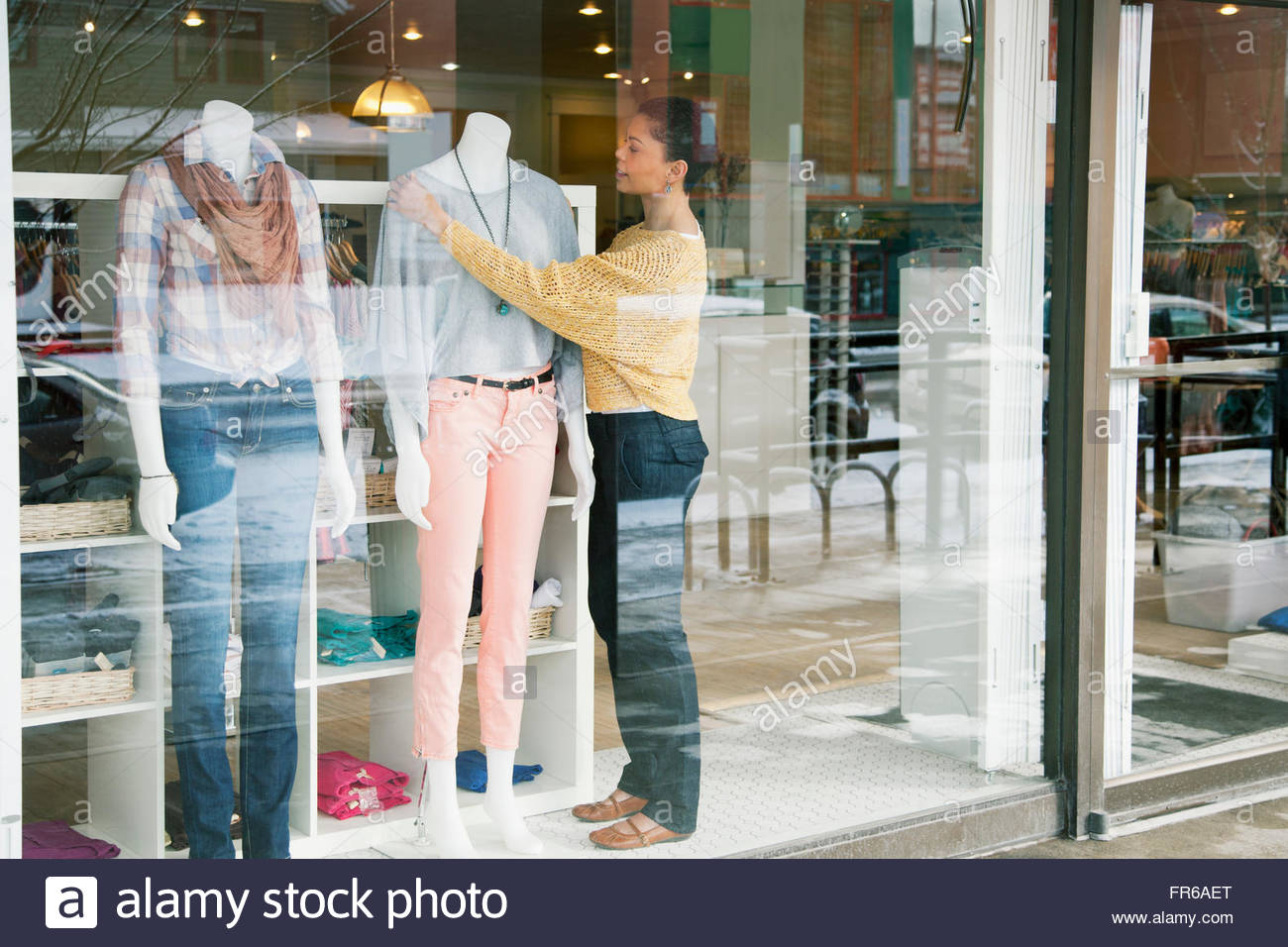 store owner propping storefront window Stock Photo - Alamy