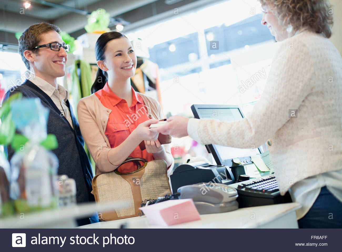 woman paying for purchase at stationery store Stock Photo - Alamy