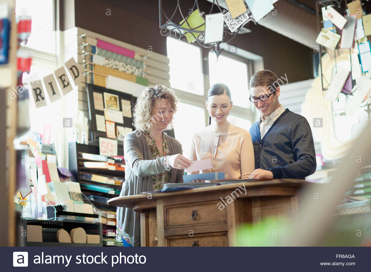 customers in discussion with store merchant Stock Photo - Alamy