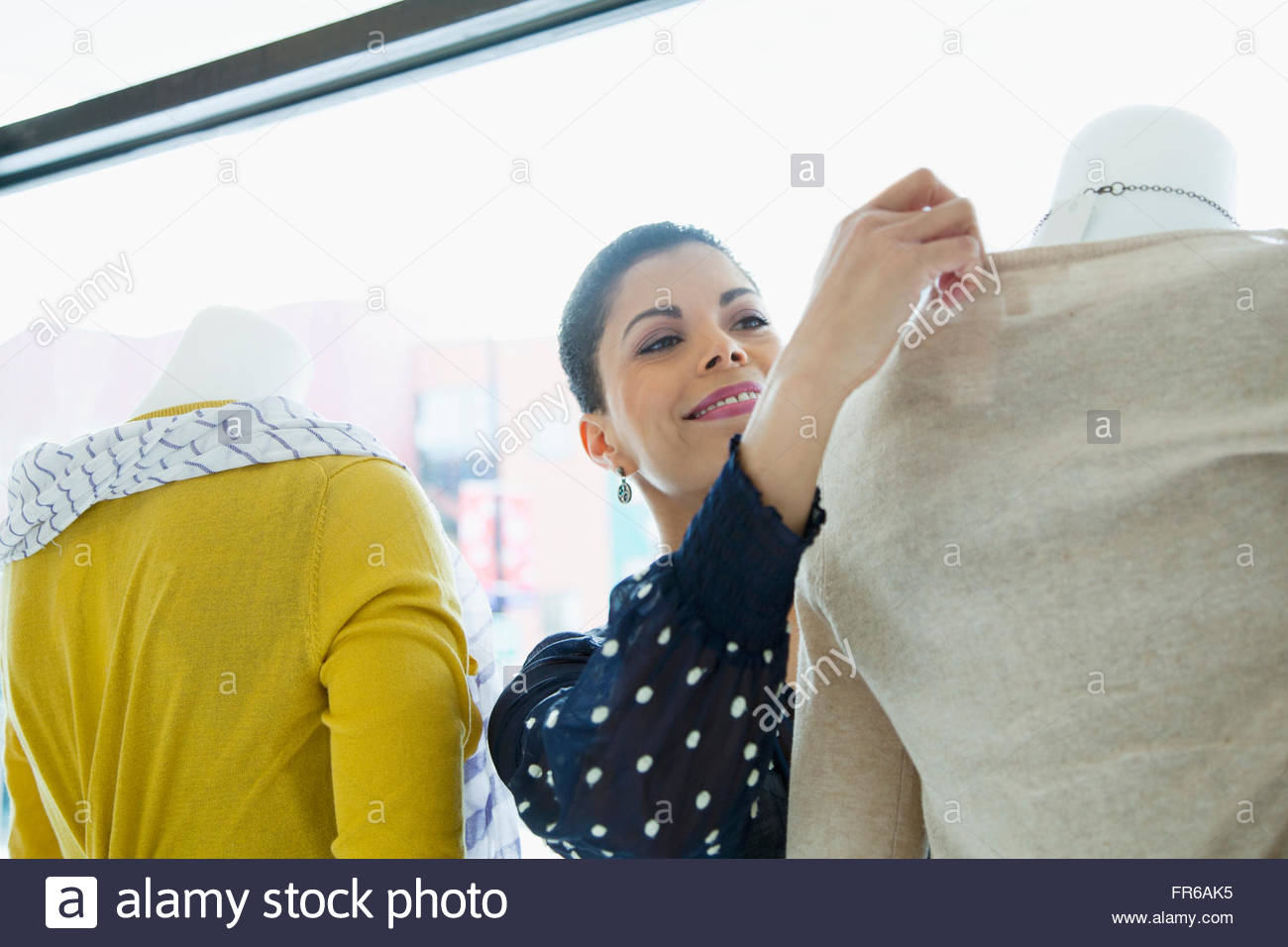 store owner propping storefront window Stock Photo - Alamy