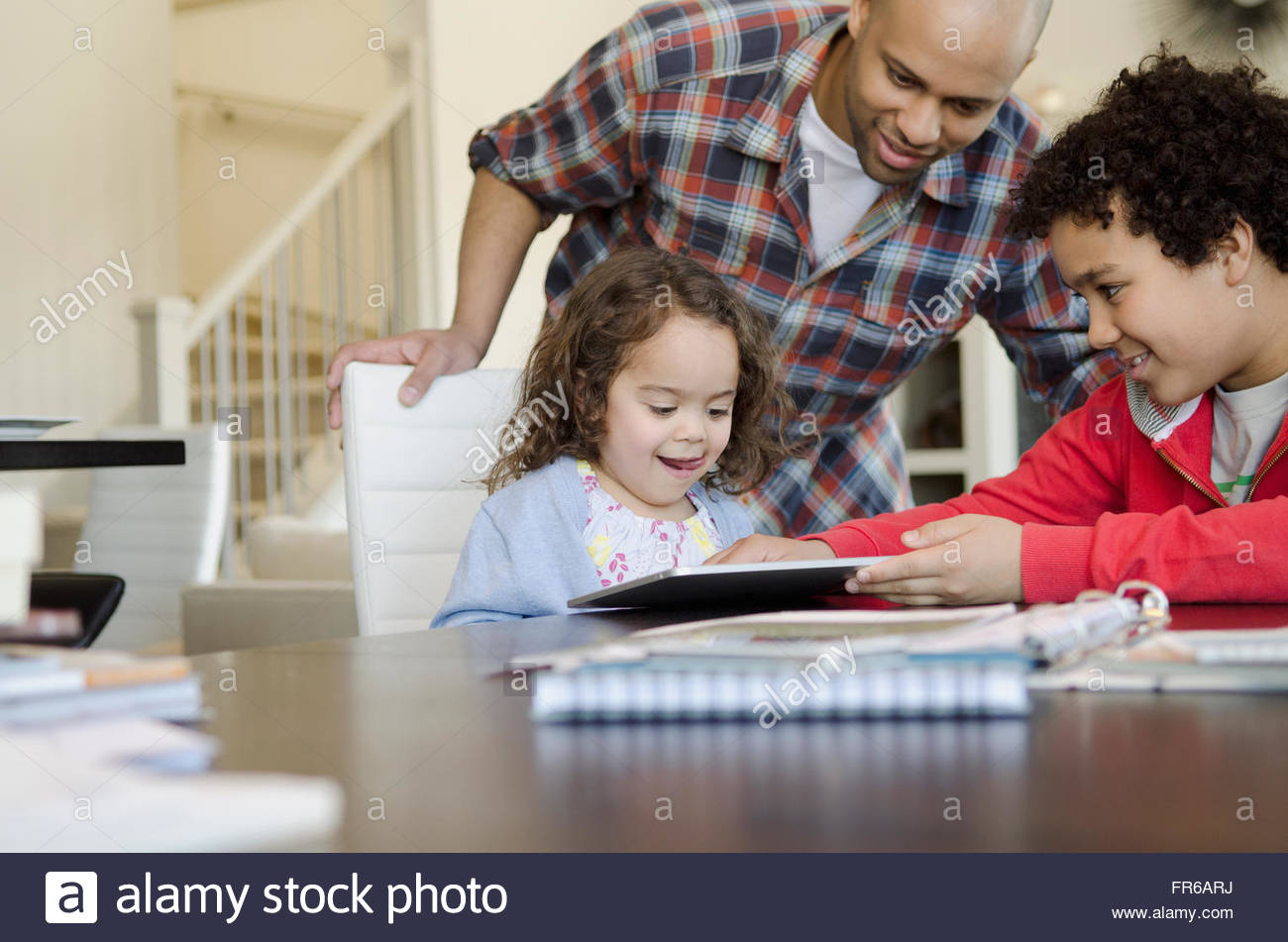 dad having fun with kids using ipad Stock Photo - Alamy