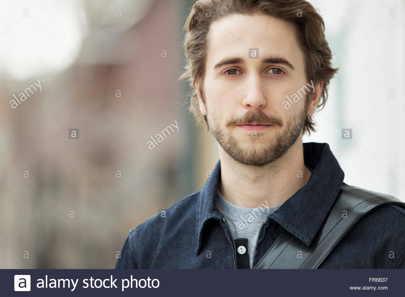 young bearded man walking in the city Stock Photo - Alamy