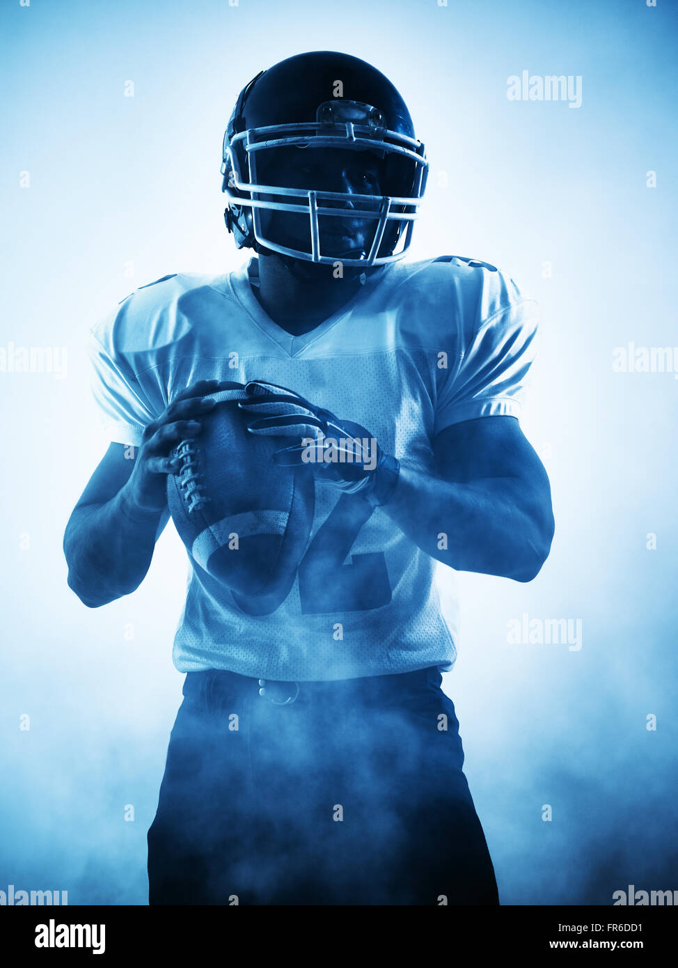 one american football player portrait in silhouette shadow on white ...