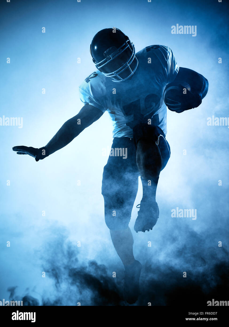 one american football player portrait in silhouette shadow on white ...