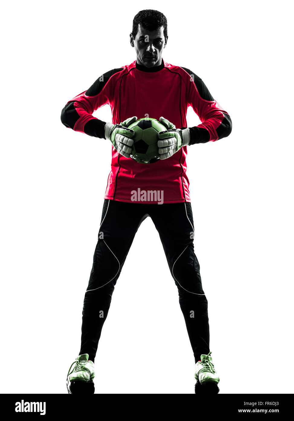one soccer player goalkeeper man standing holding ball in silhouette ...