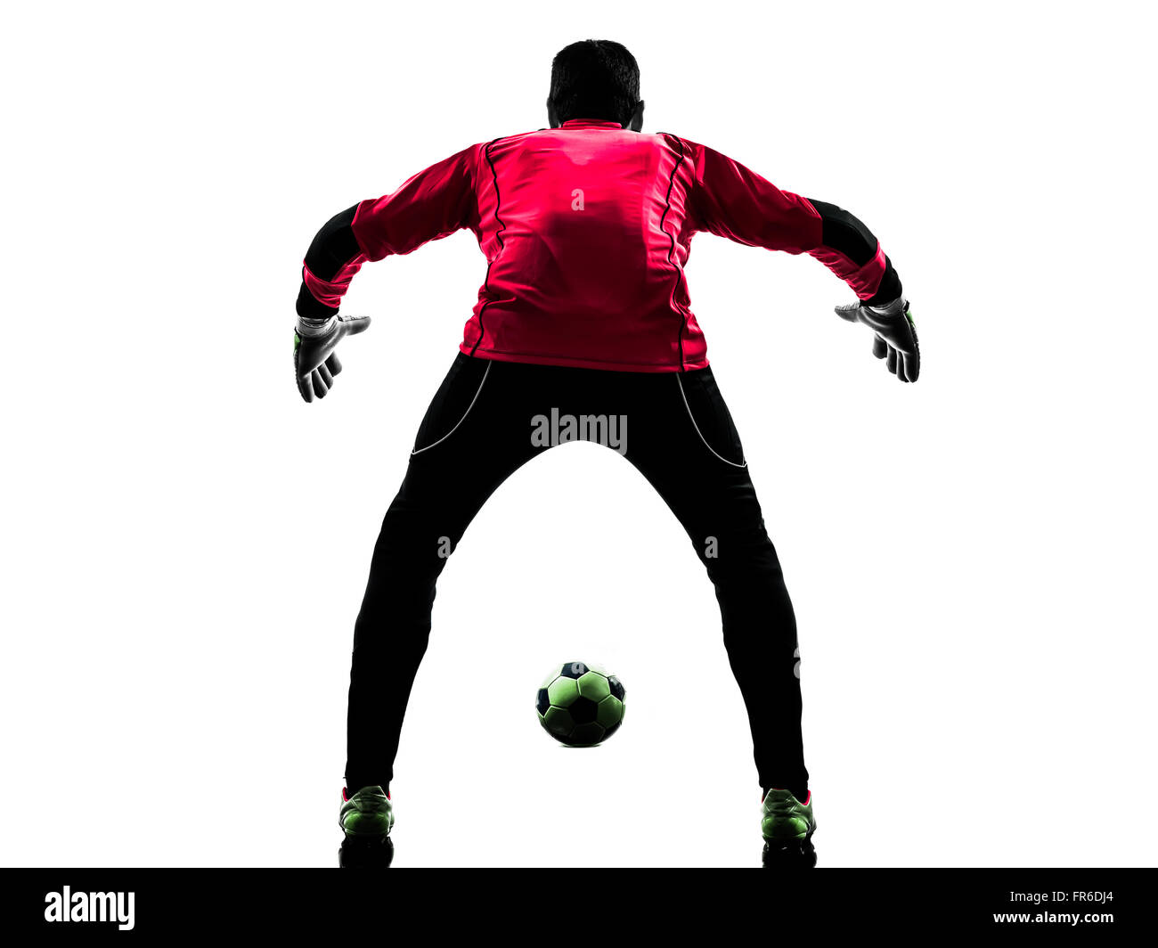 one soccer player goalkeeper man standing rear view in silhouette ...