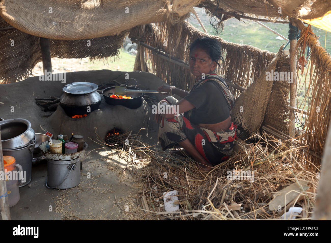 Traditional way of making food on open fire in old kitchen in a village ...
