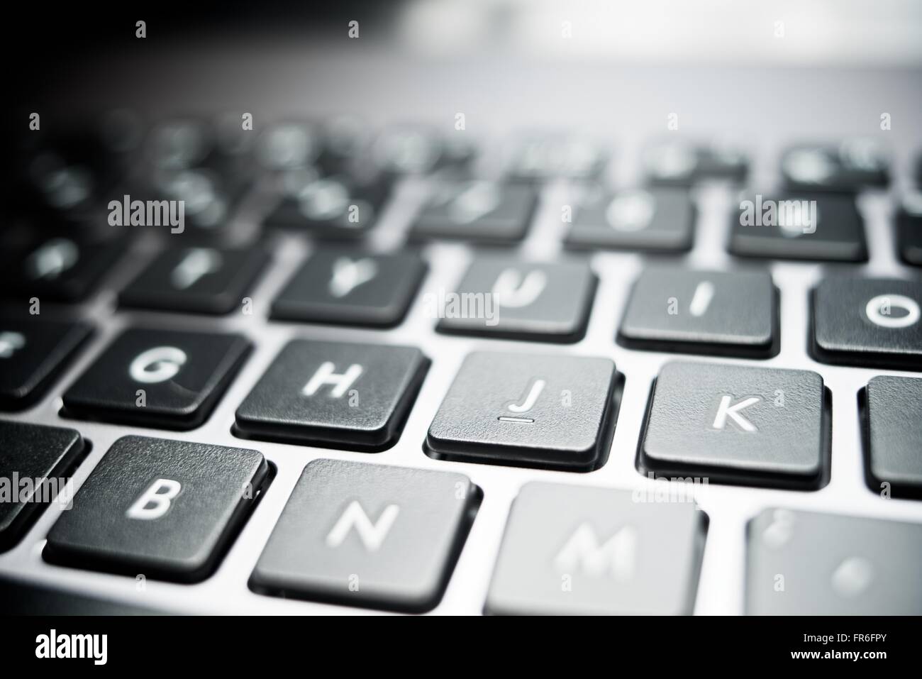 Forefront of a gray laptop keyboard Stock Photo - Alamy