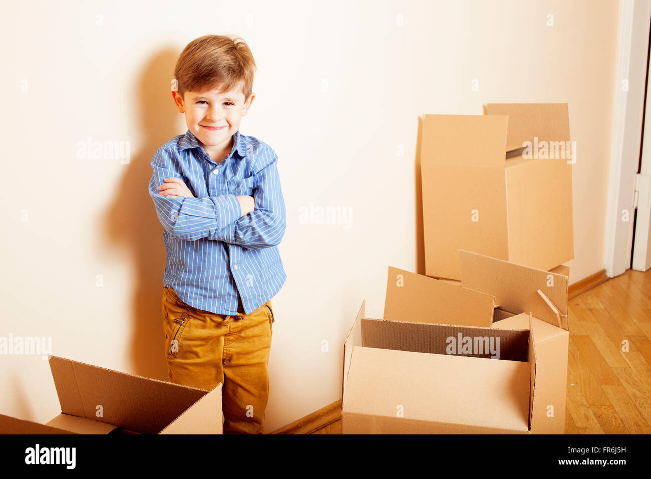 little cute boy in empty room, remoove to new house. home alone emong ...
