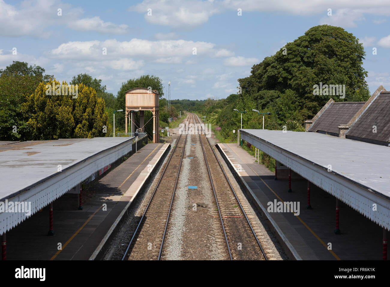 Steel rail way ine or tracks run through a country station at Kemble ...