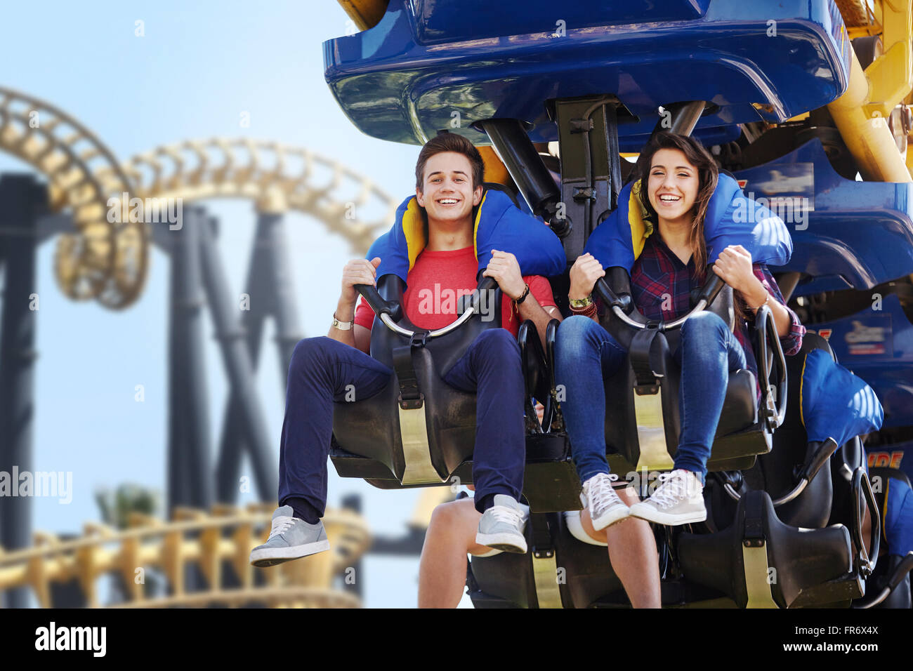 Young couple riding amusement park ride Stock Photo - Alamy