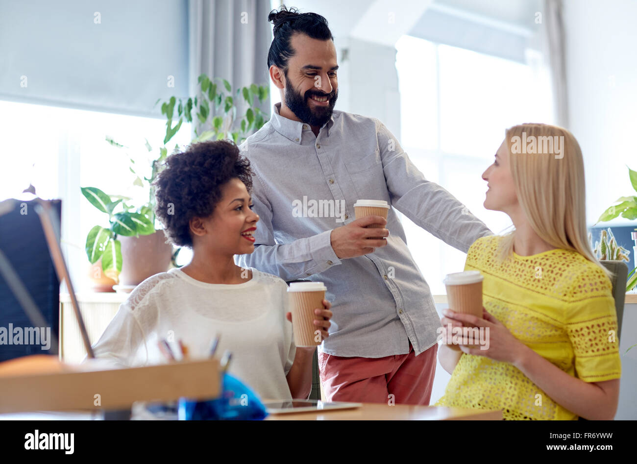 happy creative team drinking coffee in office Stock Photo - Alamy