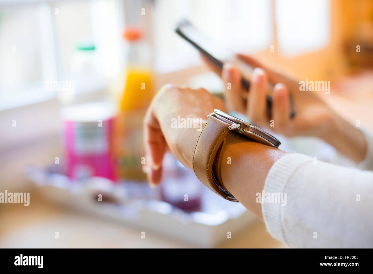 Female with mobile phone connected to a smartwatch Stock Photo - Alamy