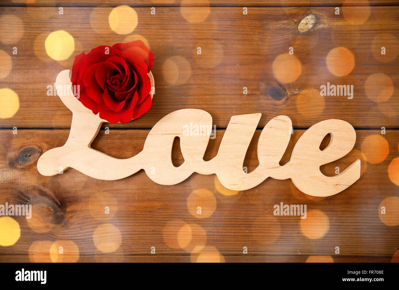 close up of word love cutout with red rose on wood Stock Photo - Alamy