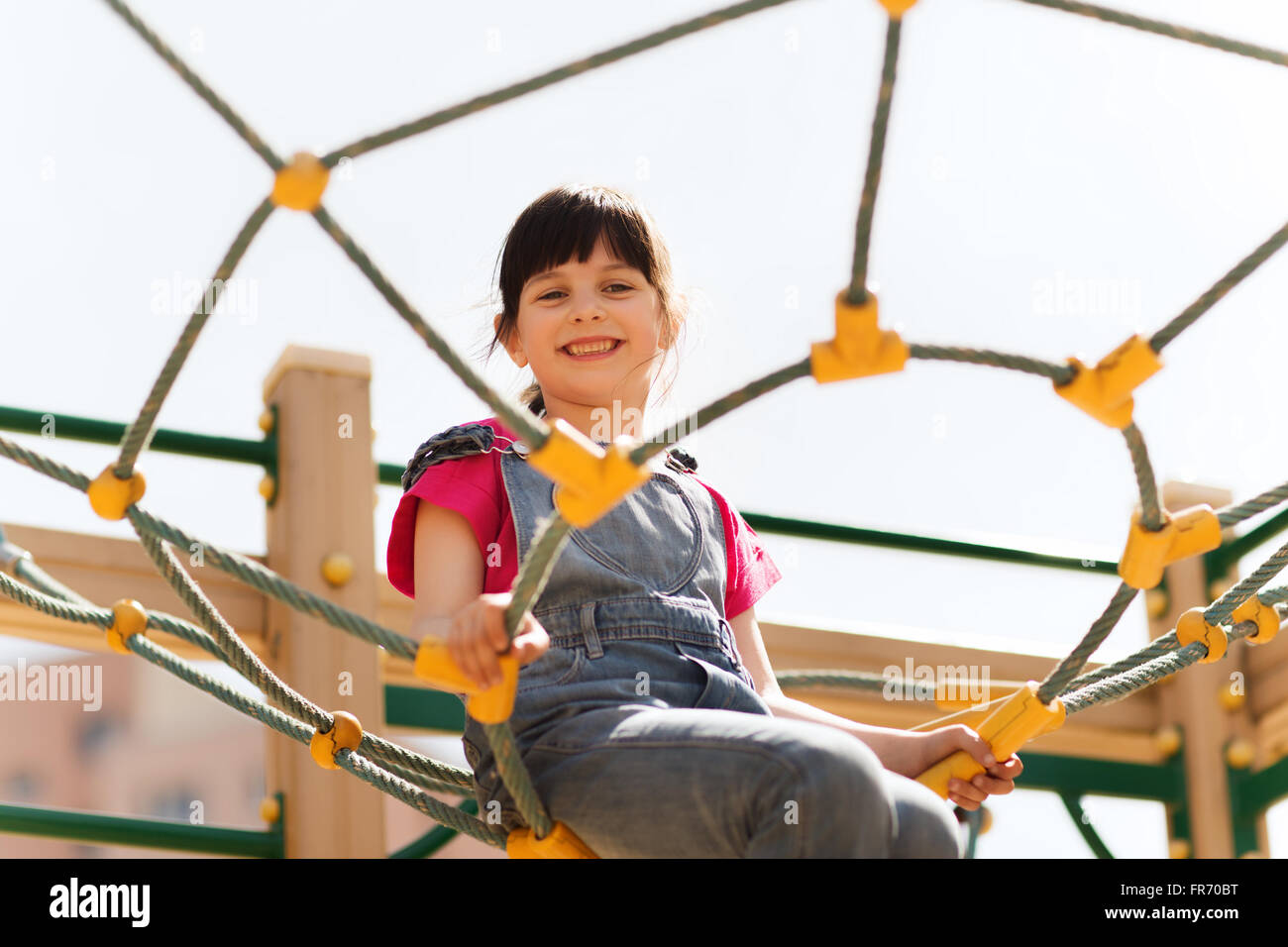happy little girl climbing on children playground Stock Photo - Alamy