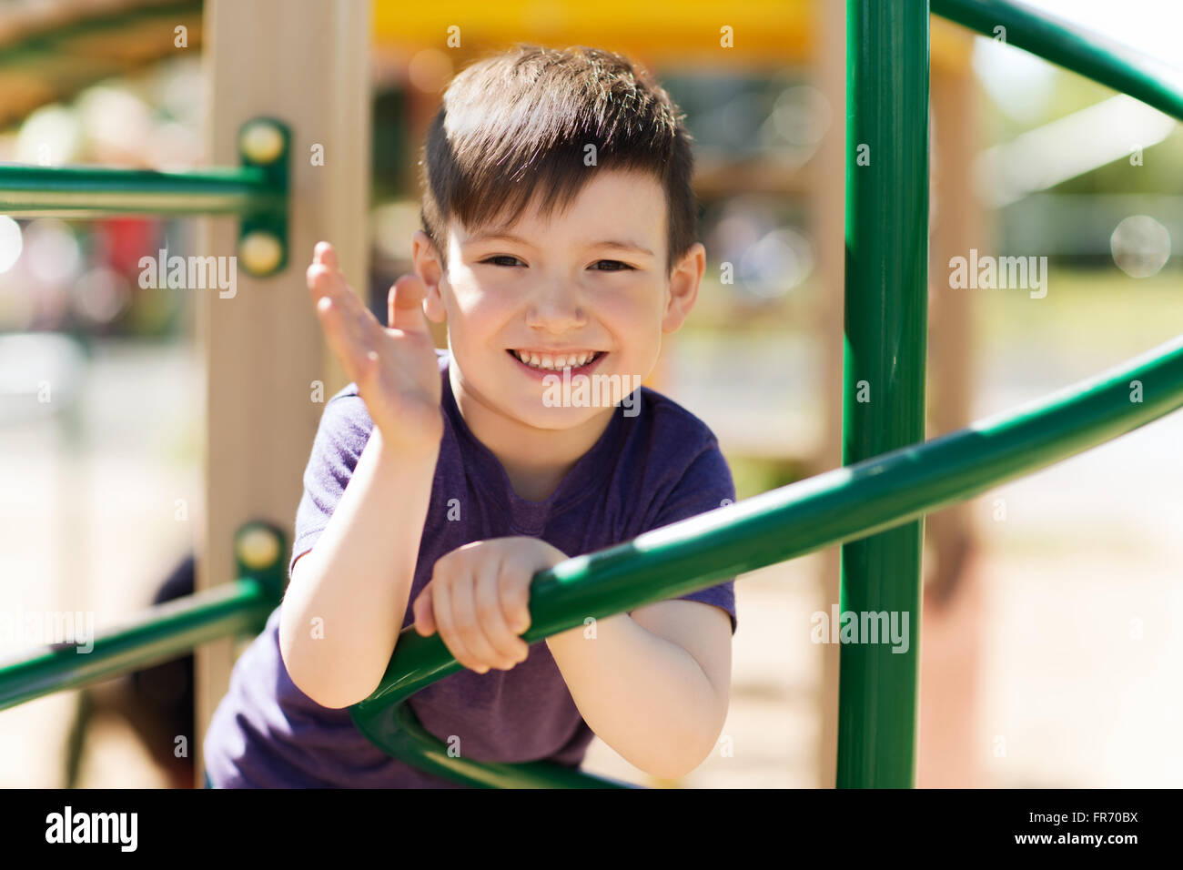 happy little boy climbing on children playground Stock Photo - Alamy