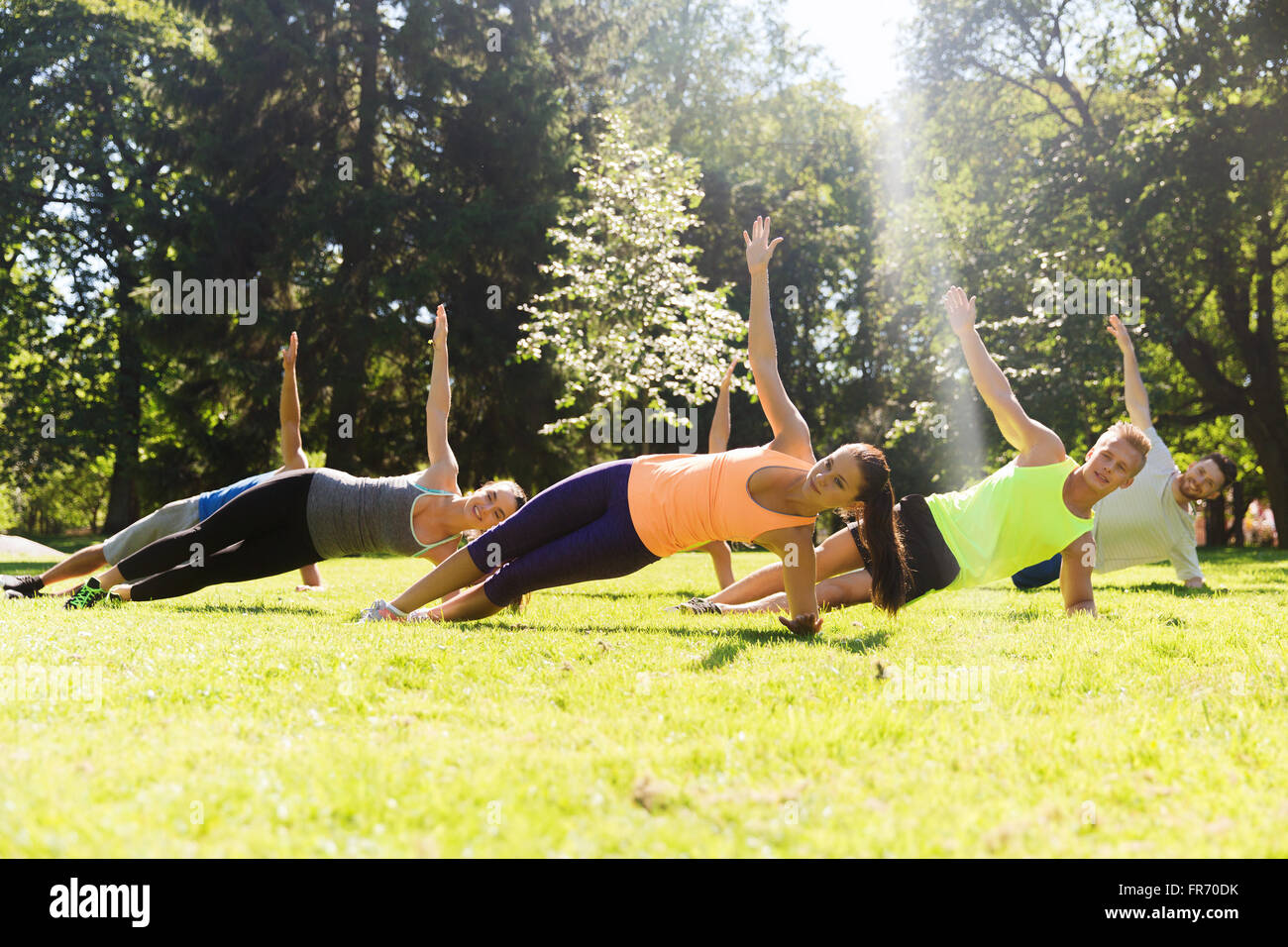 group of happy friends exercising outdoors Stock Photo - Alamy