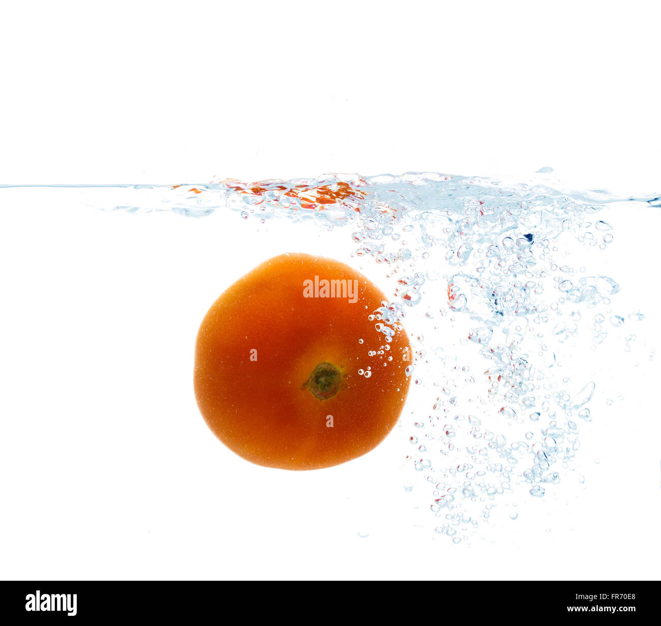 tomato falling or dipping in water with splash Stock Photo - Alamy