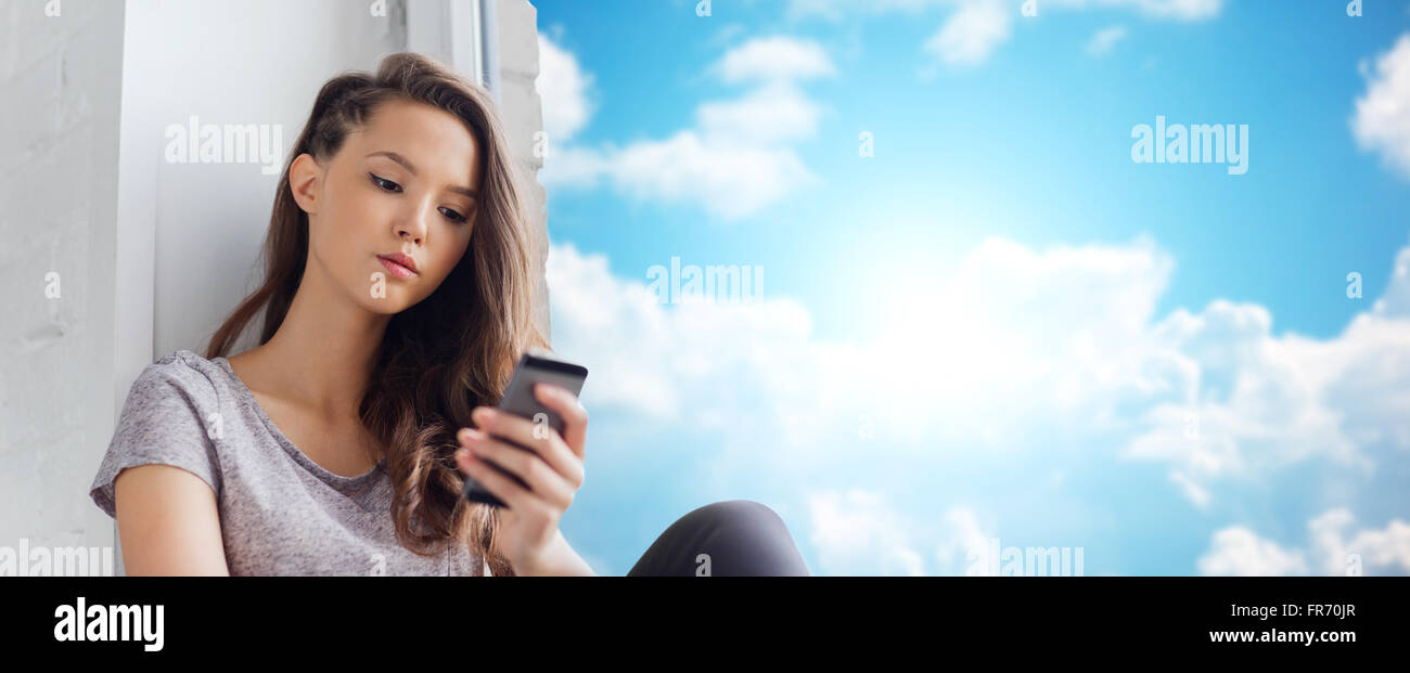 sad pretty teenage girl with smartphone texting Stock Photo - Alamy