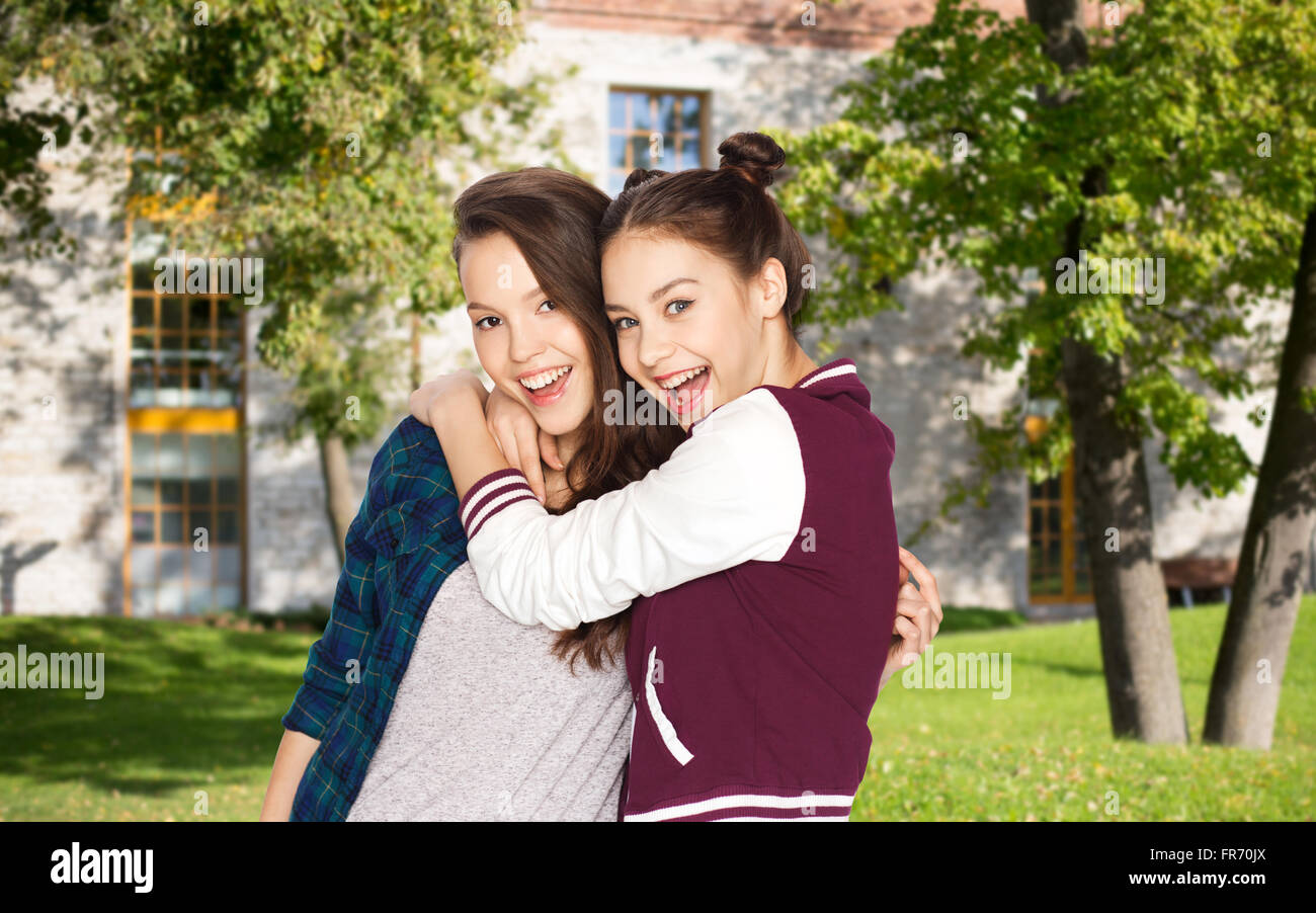 happy teenage student girls hugging over campus Stock Photo - Alamy