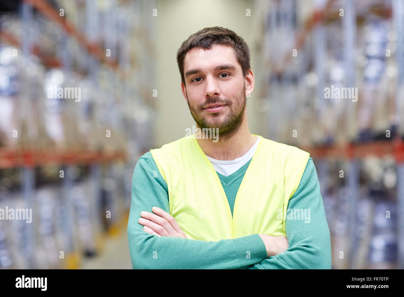 happy man in reflective safety vest at warehouse Stock Photo - Alamy