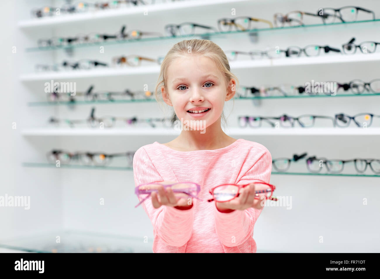 little girl in glasses at optics store Stock Photo - Alamy