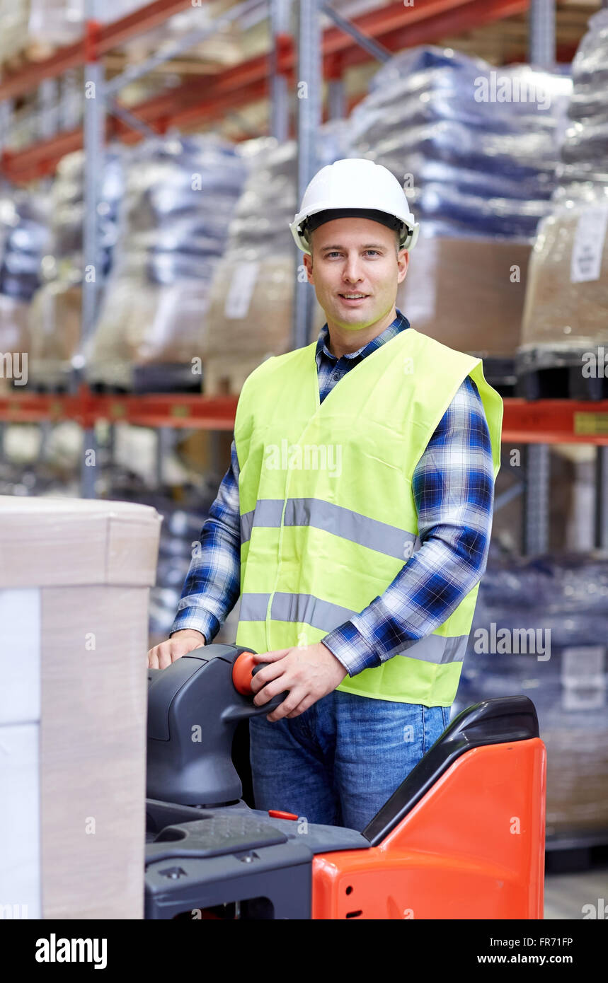 man on forklift loading boxes at warehouse Stock Photo - Alamy