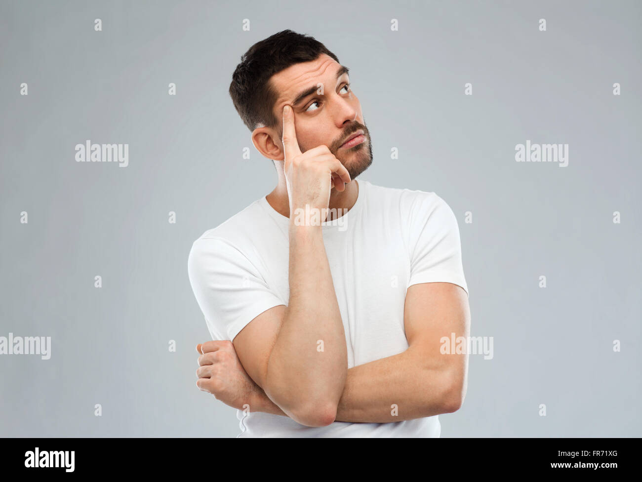 man thinking over gray background Stock Photo - Alamy