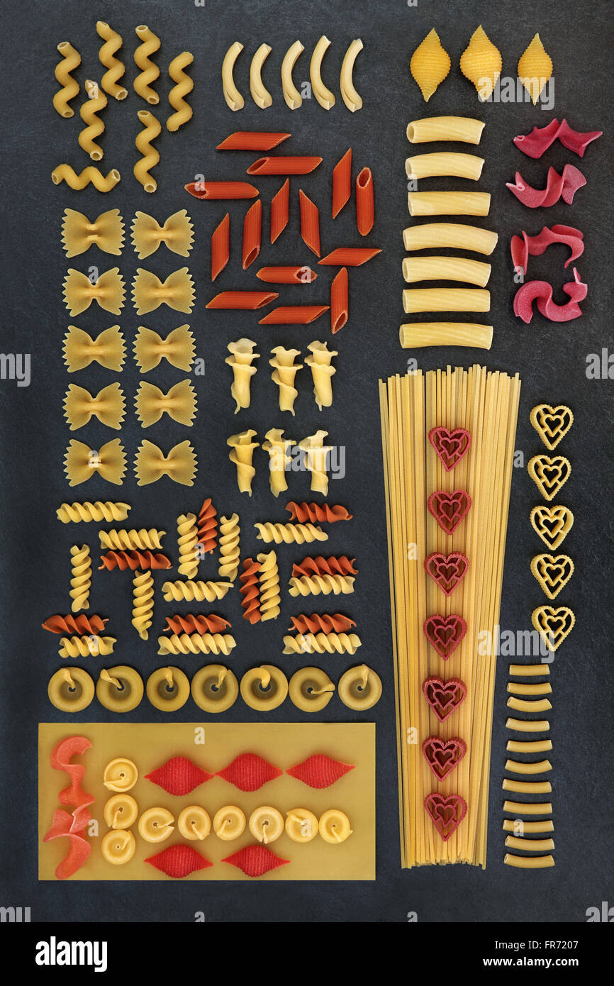 Pasta selection with coloured italian varieties over slate background ...