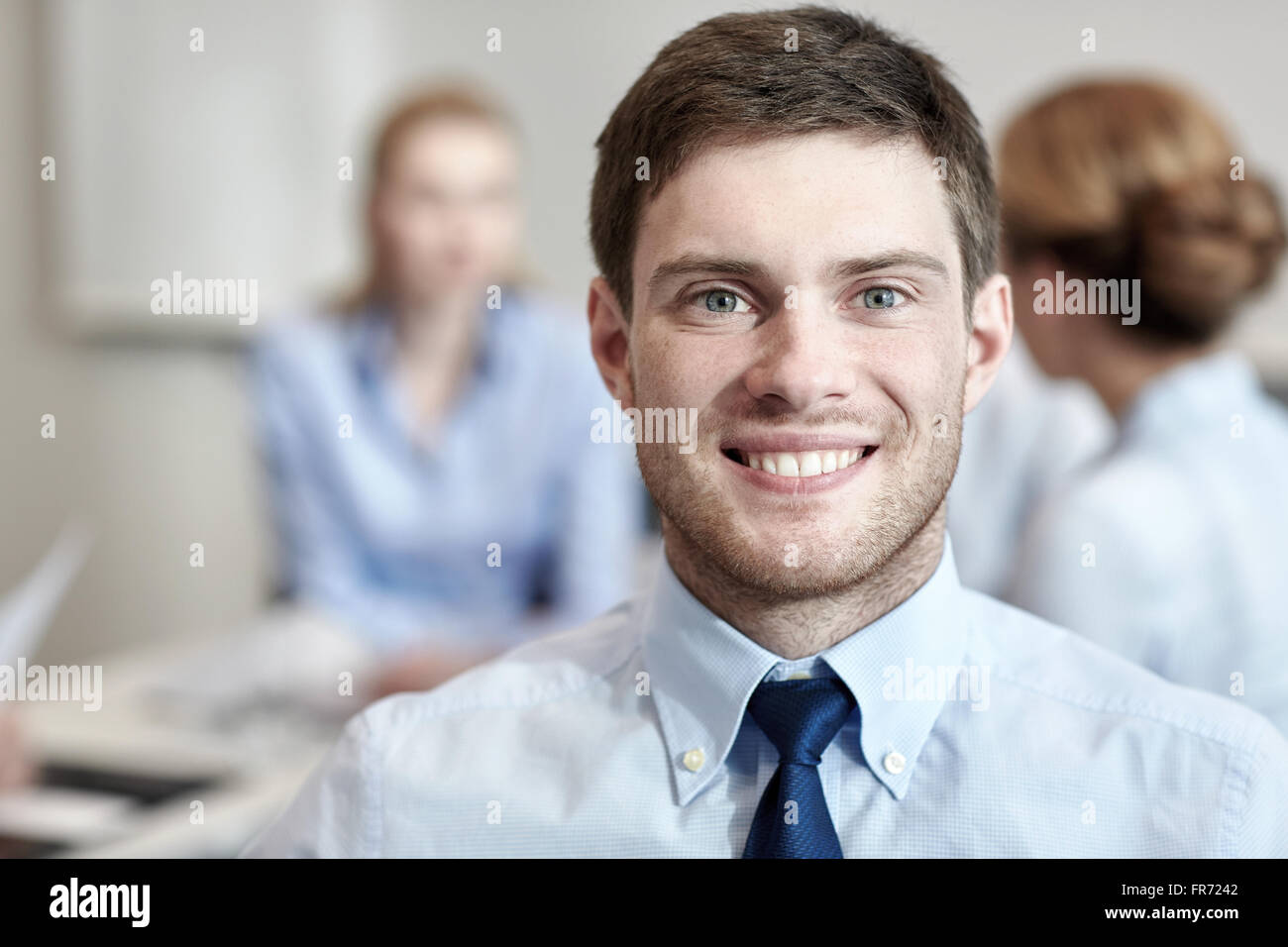 smiling businessman face in office Stock Photo - Alamy