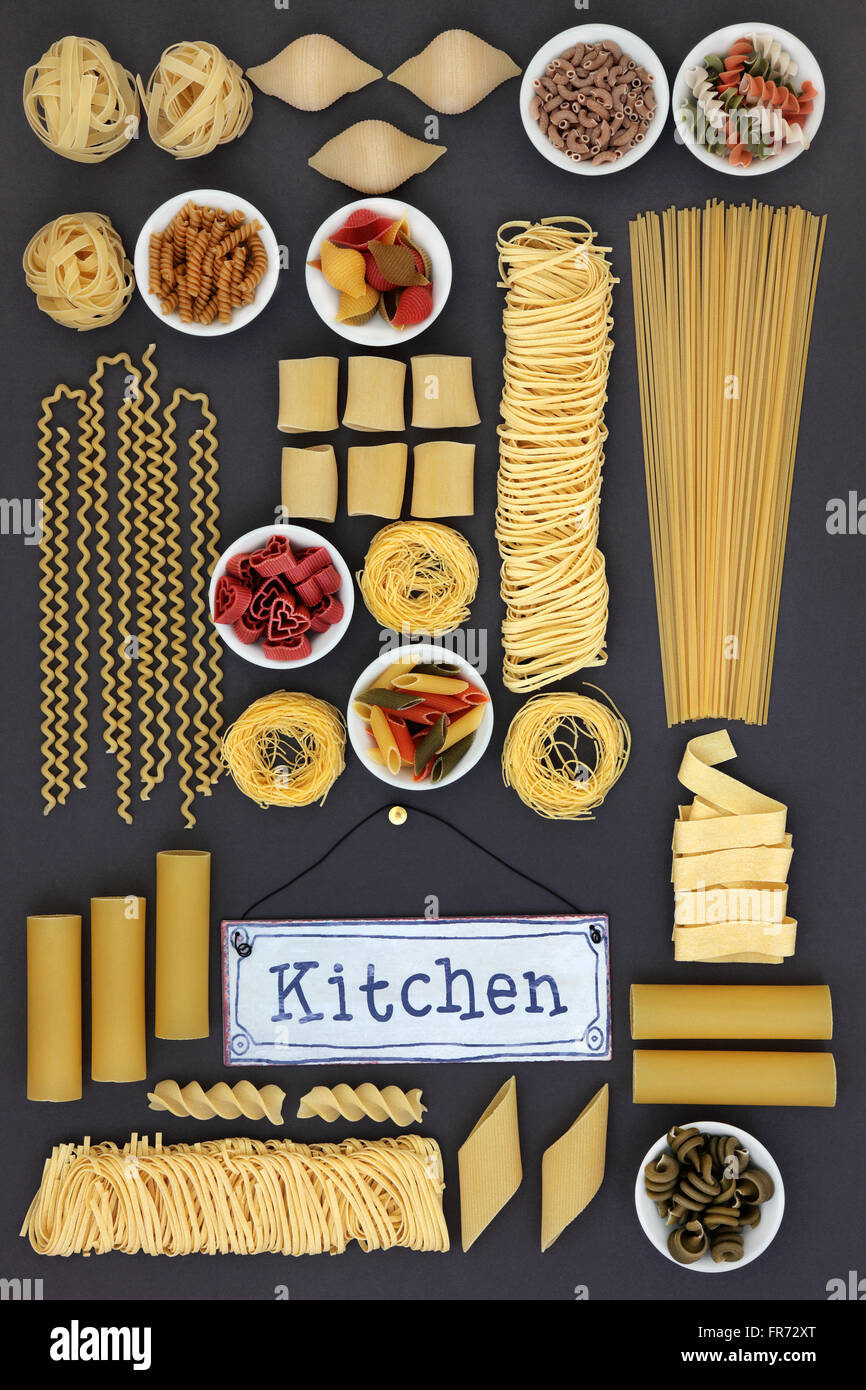 Large dried italian pasta food sampler with old metal kitchen sign on ...
