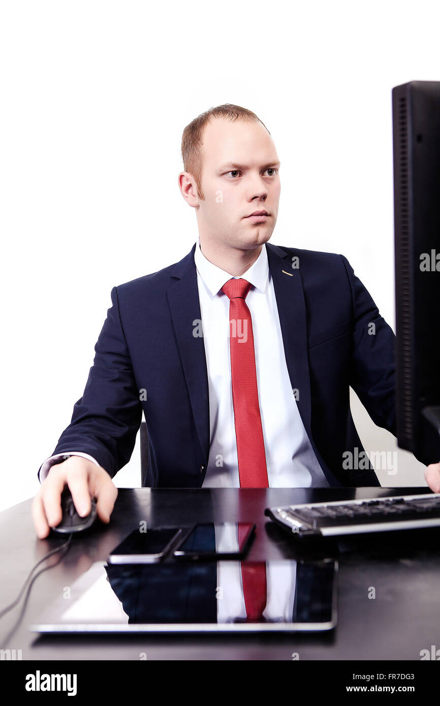 German businessman working in the workplace computer. Phone, tablet ...