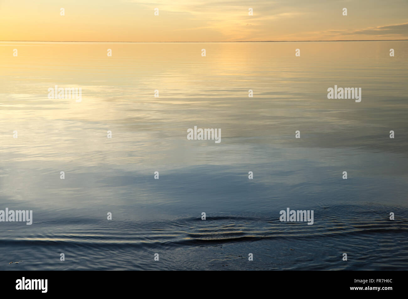 Absolute calm and smooth water with colorful evening light Stock Photo ...