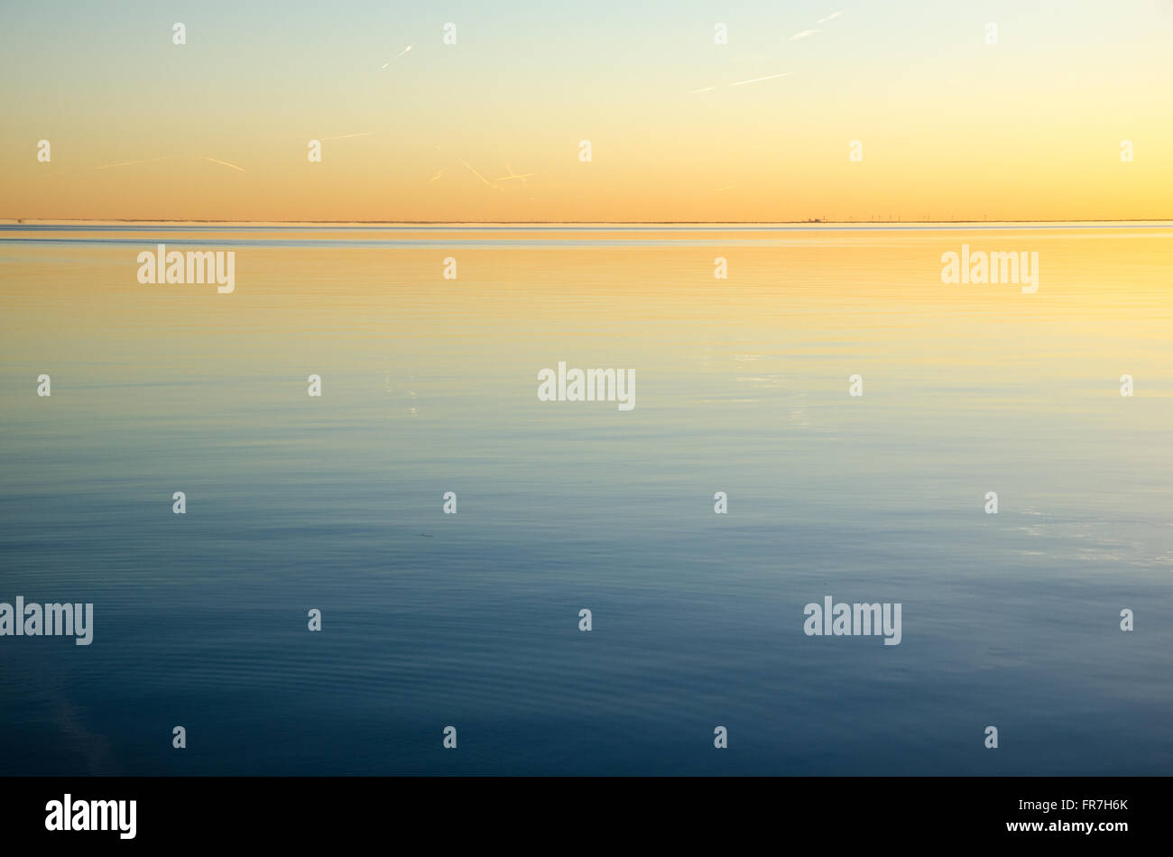 Bright sunset colors in the sky and in the calm smooth water Stock ...