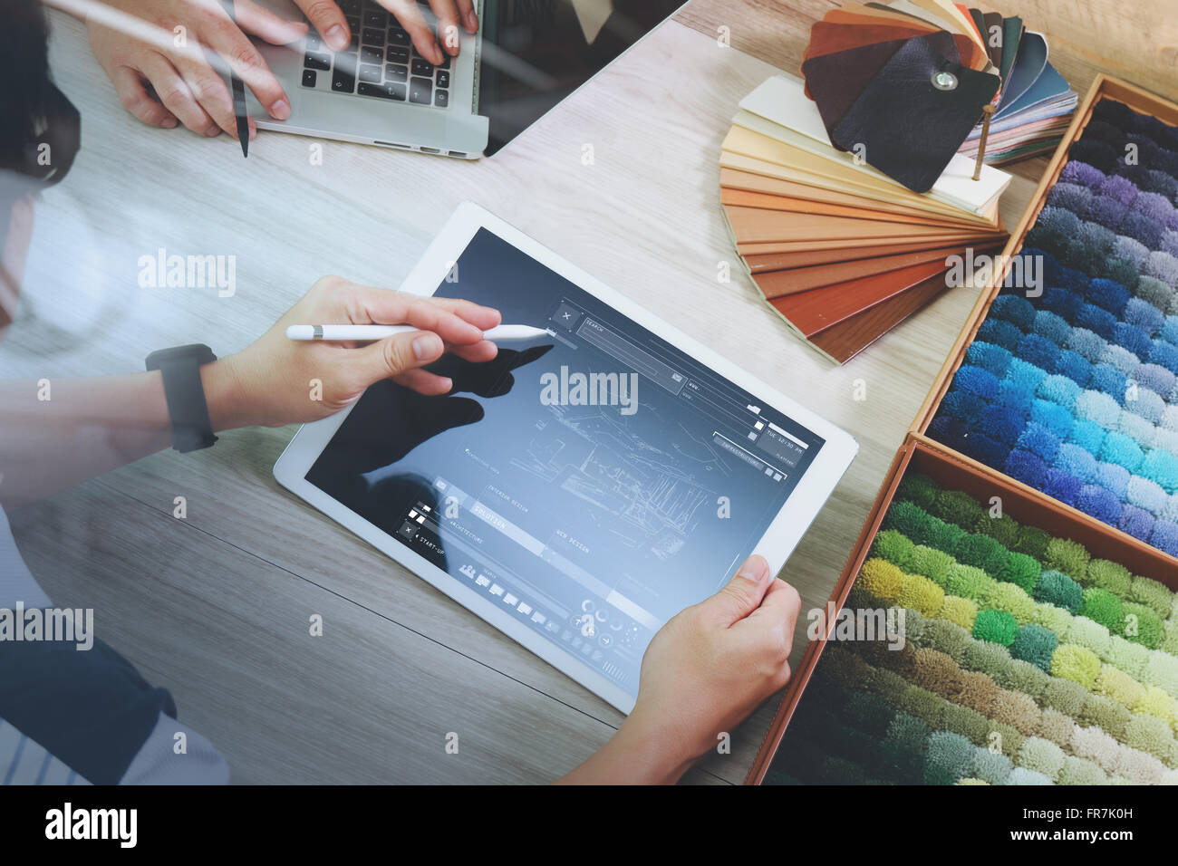 top view of two colleagues interior designers discussing data with ...