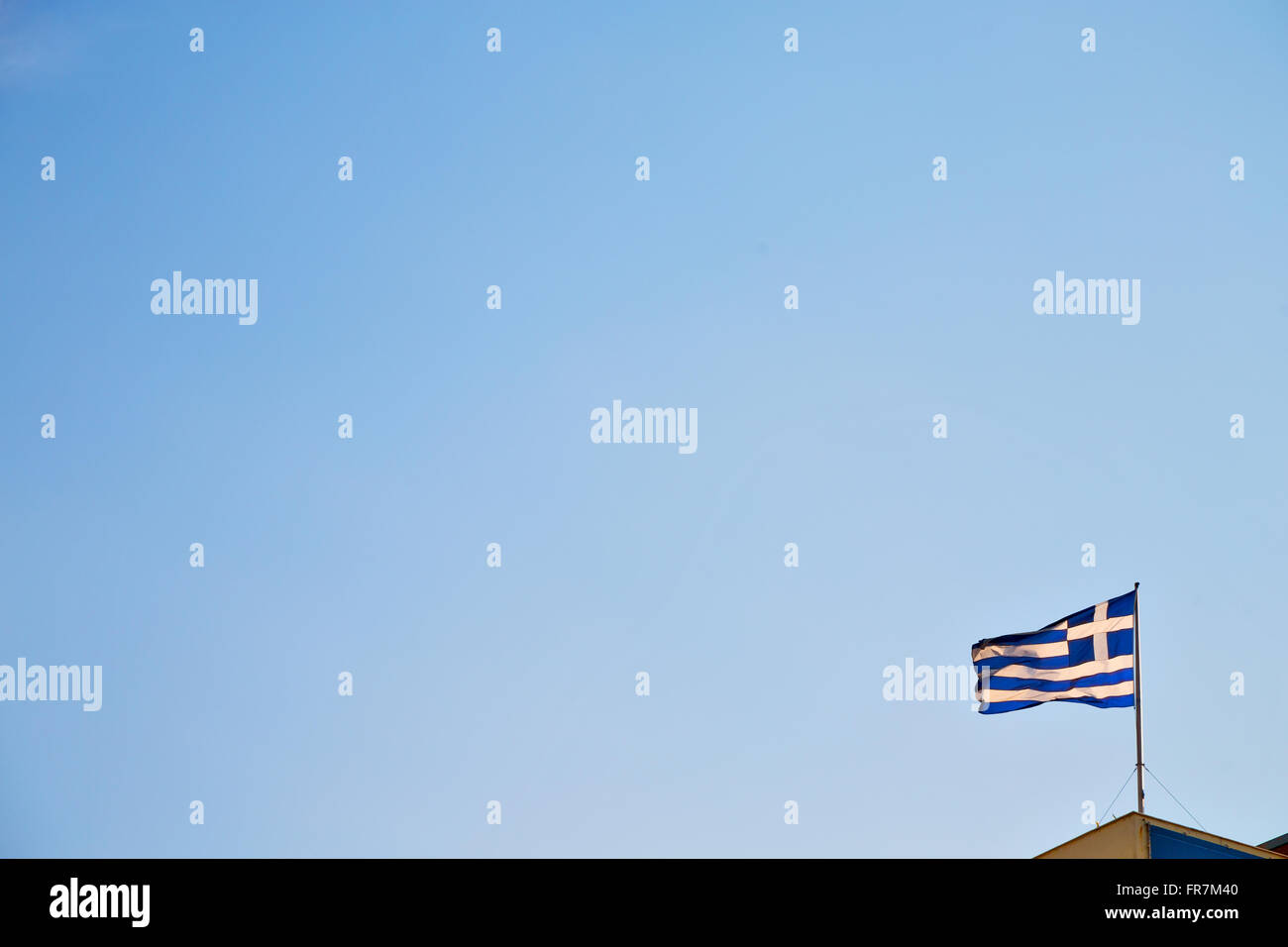 waving greece flag in the blue sky and flagpole Stock Photo - Alamy