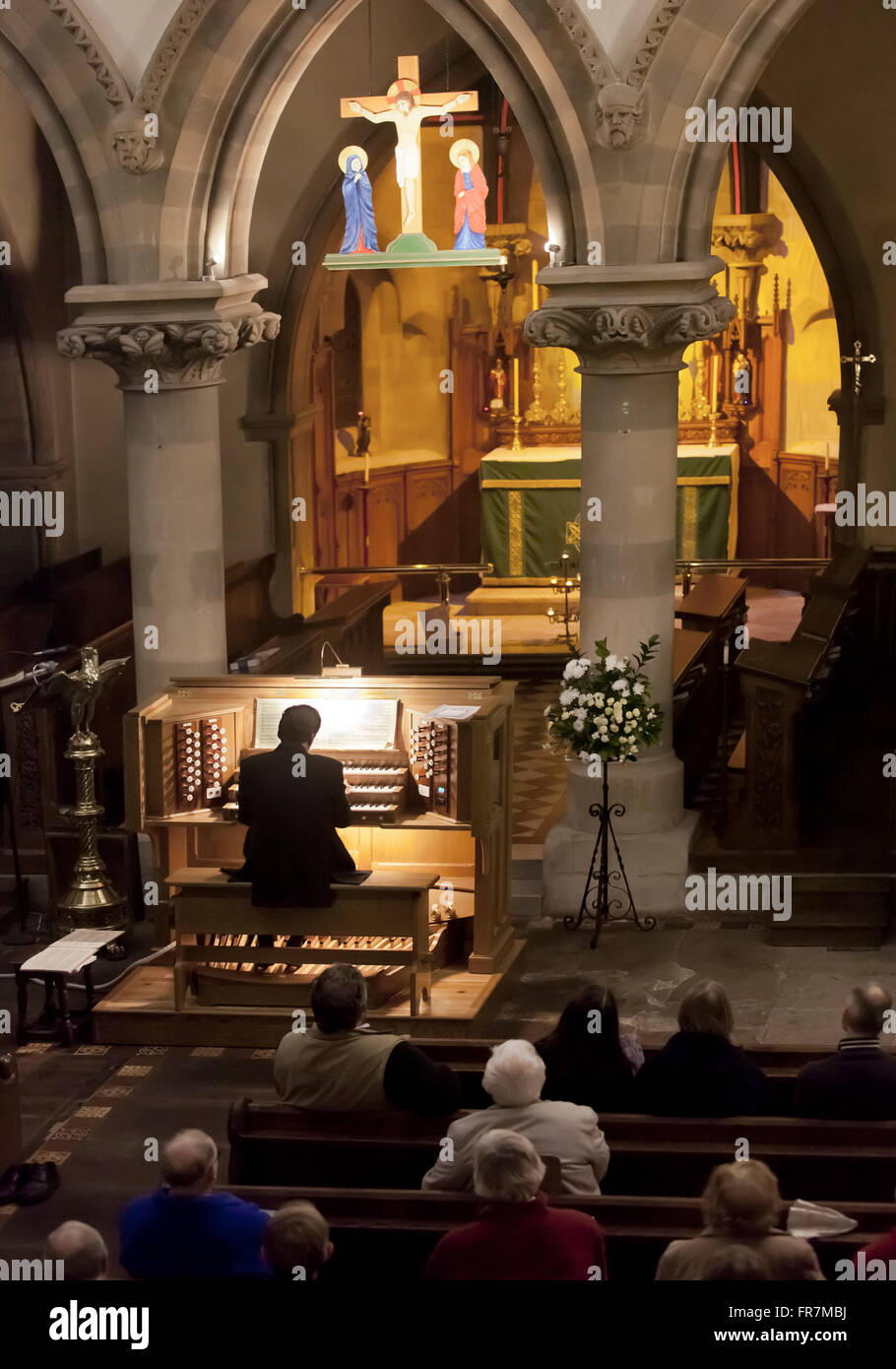 Priest plays the organ in Anglo-Catholic church in Wales Stock Photo ...
