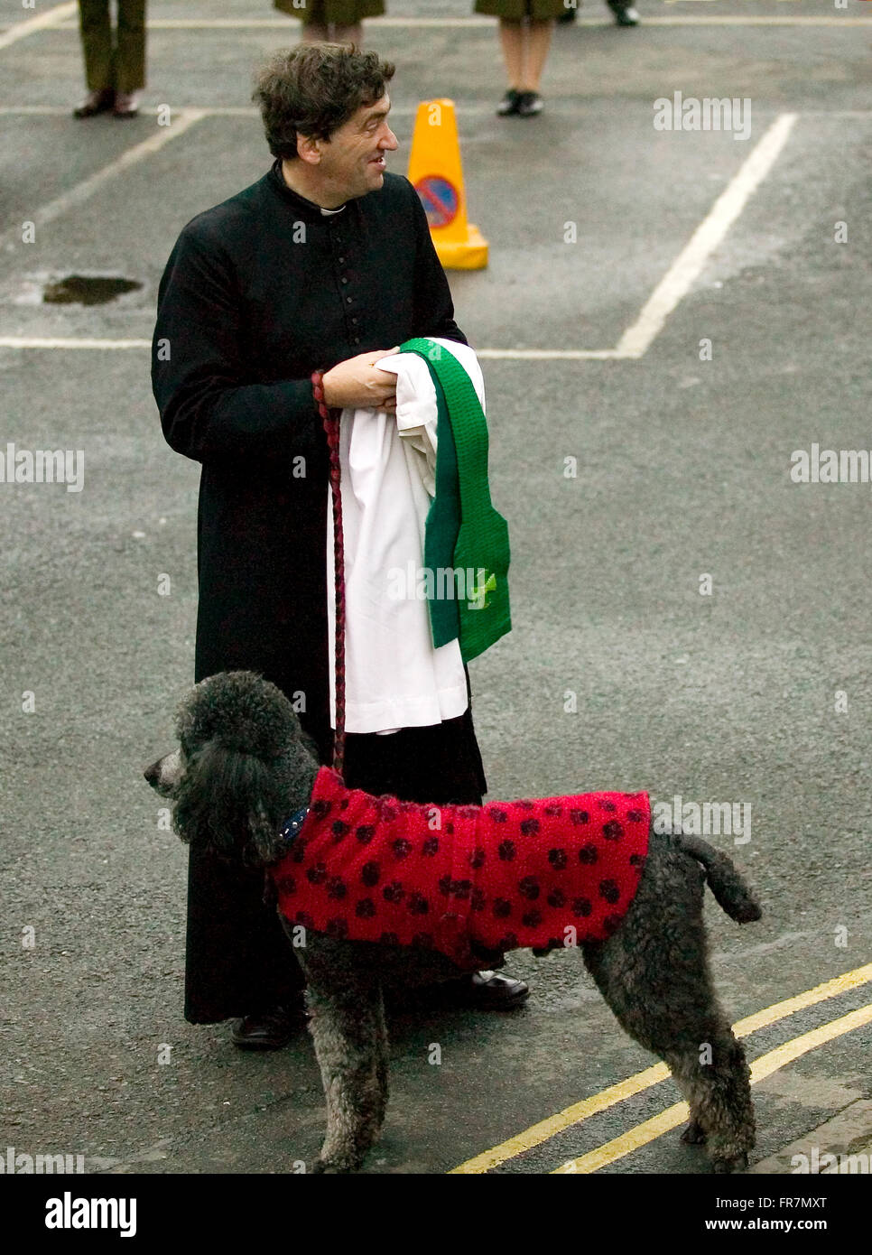 Anglican priest after Remembrance Sunday service with his dog Stock ...