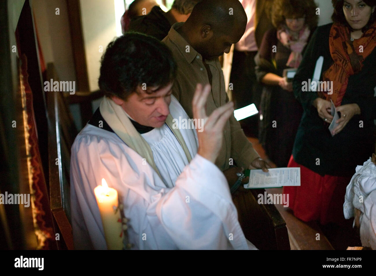 Priest giving a blessing at a baptism Stock Photo - Alamy