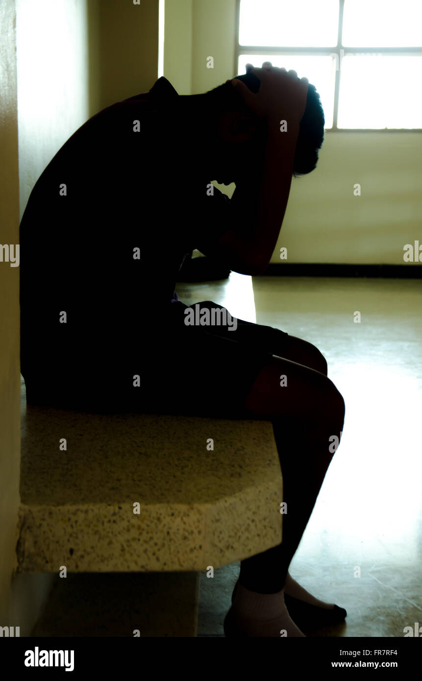 depress young boy sitting on the floor Stock Photo - Alamy