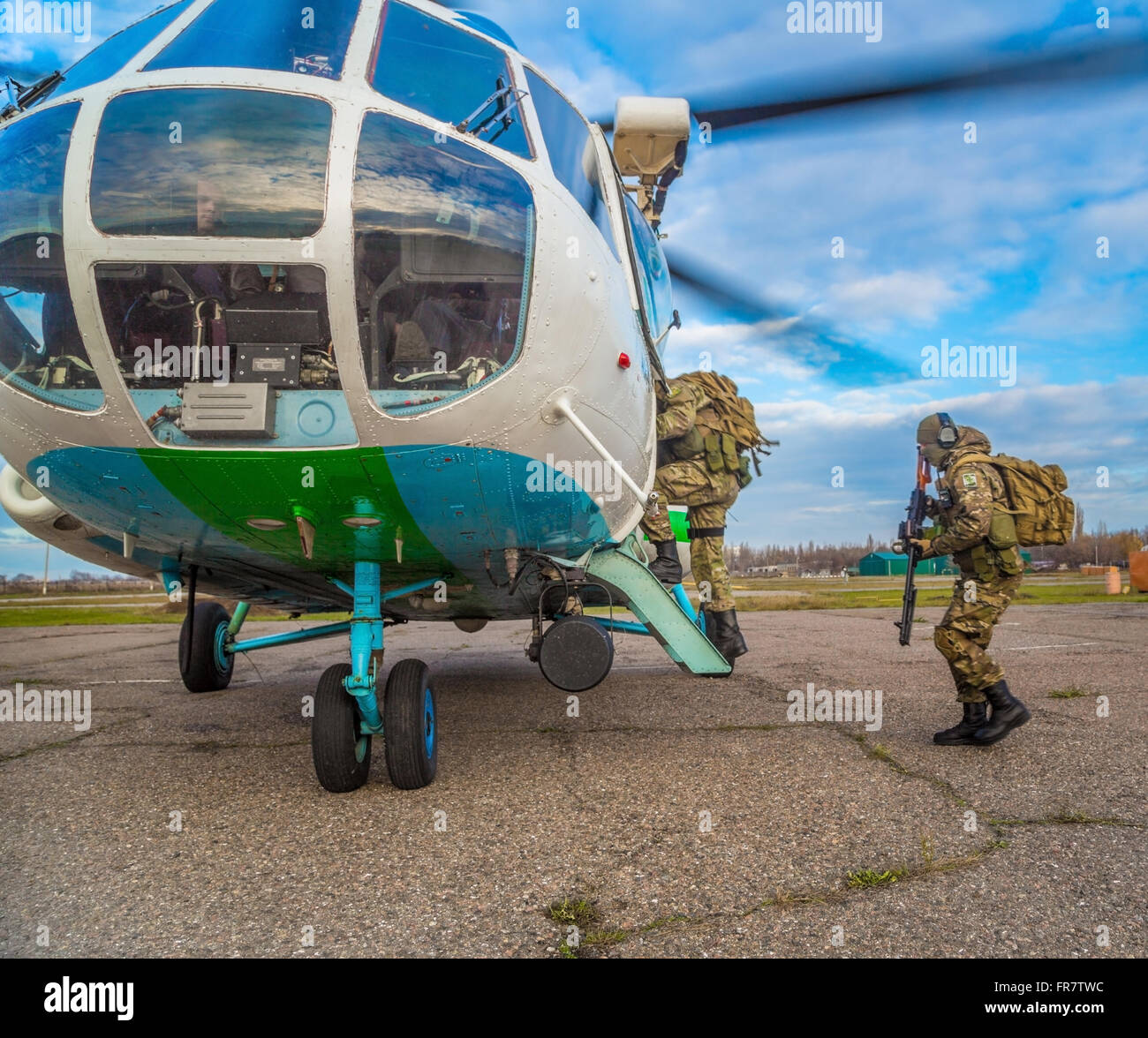 Soldiers and helicopter Stock Photo - Alamy