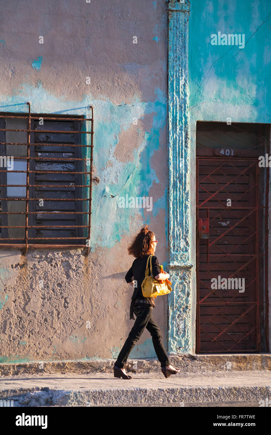 young woman walking along street in Cuba Stock Photo - Alamy