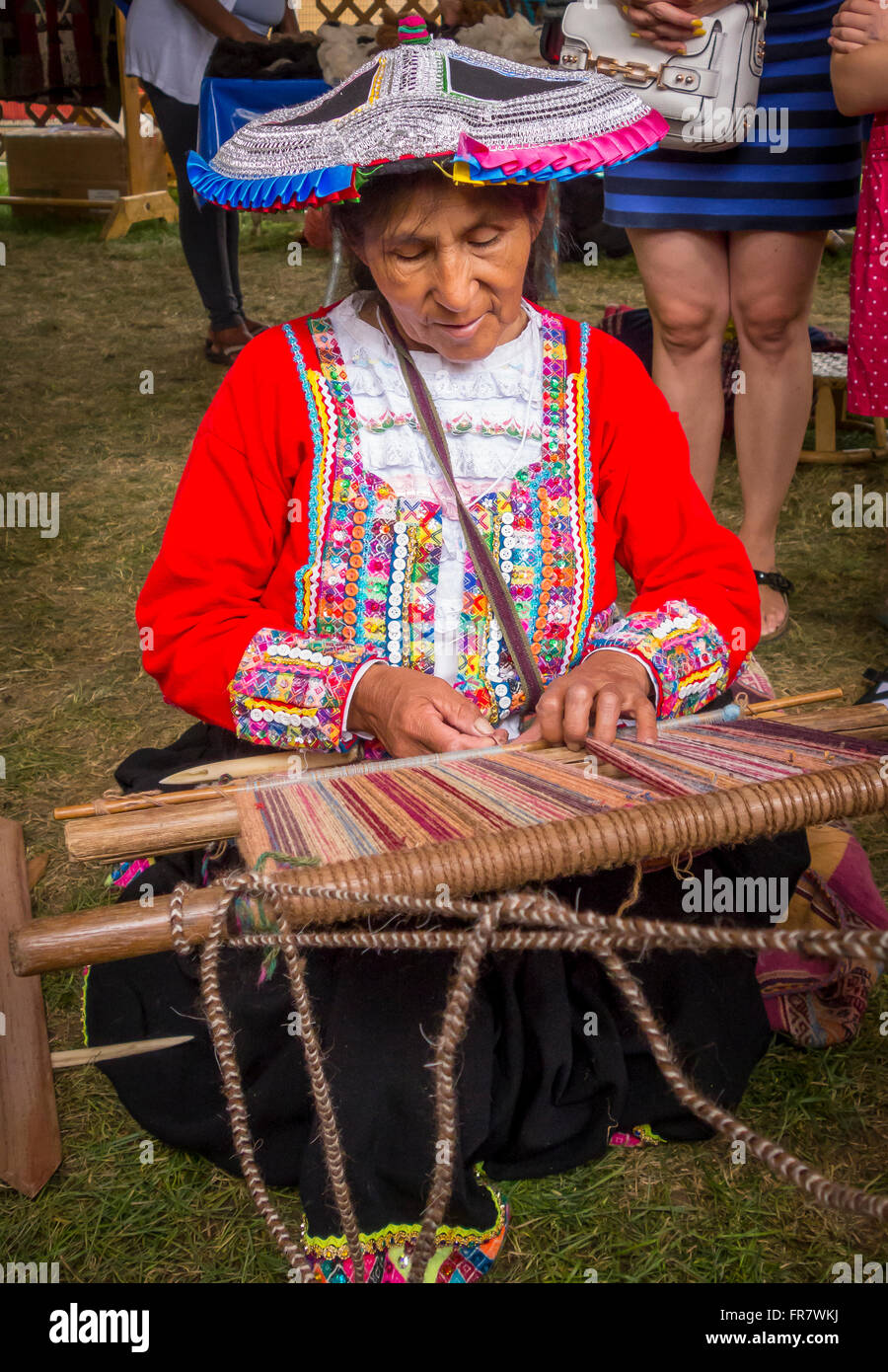 WASHINGTON, DC, USA - Woman demonstrates weaving by hand with backstrap ...